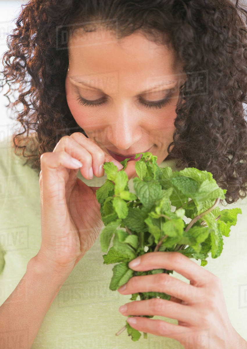Woman smelling fresh mint - Royalty-free Stock Photo | Dissolve