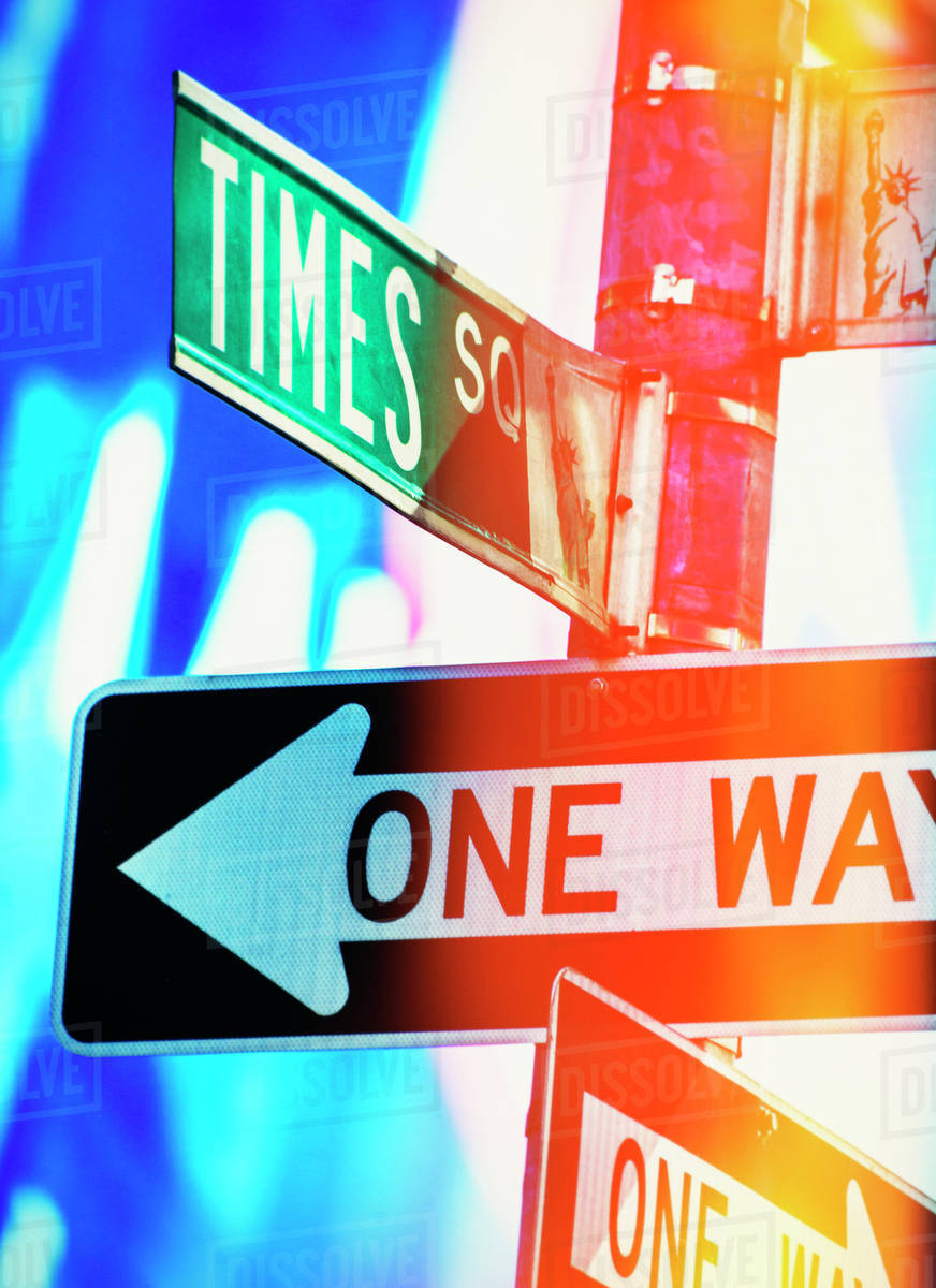 Directional signs at night - Stock Photo - Dissolve