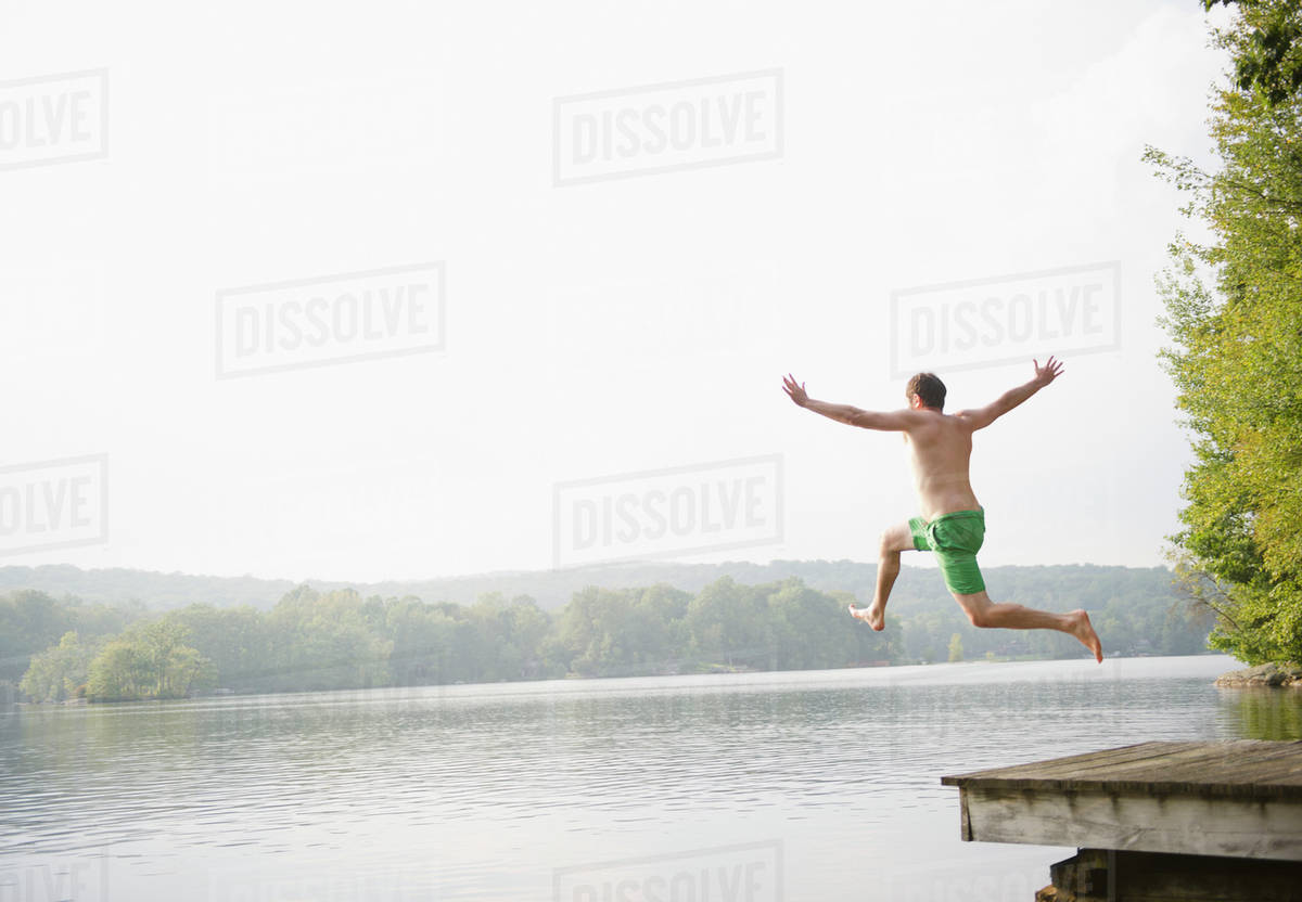 Roaring Brook Lake, Man jumping from pier to lake - Royalty-free Stock ...