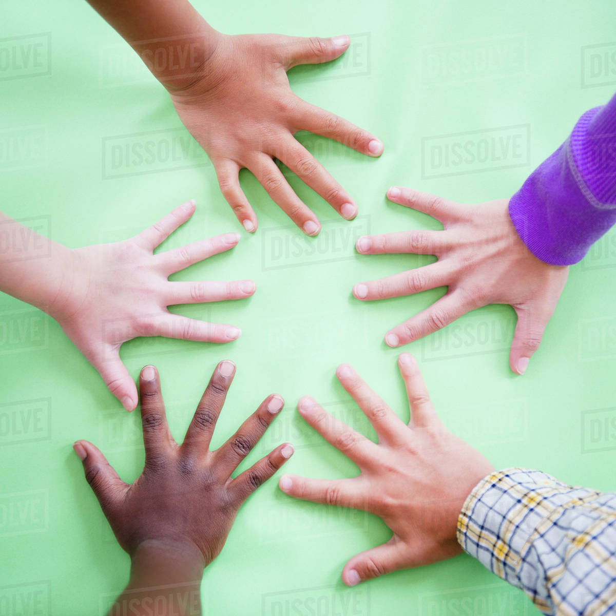 Close up of children's (8-9) hands on green background - Stock Photo ...