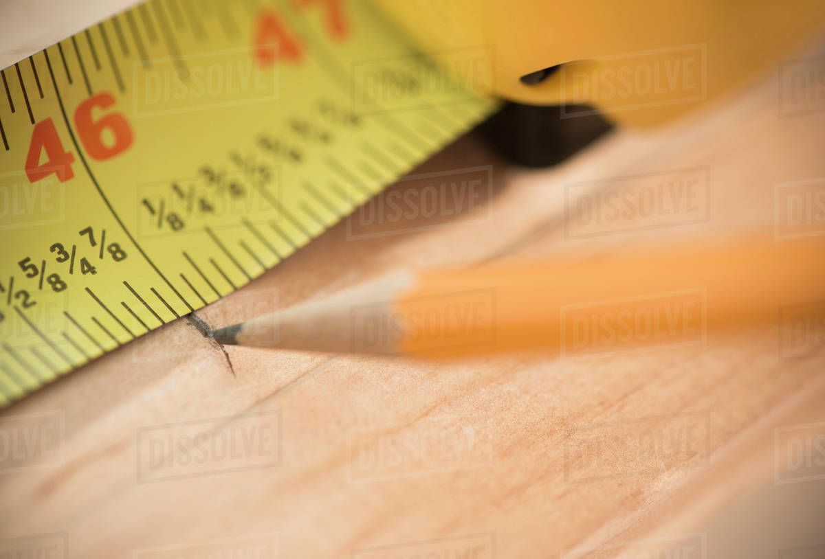 Close-up of tape measure and pencil - Royalty-free Stock Photo | Dissolve