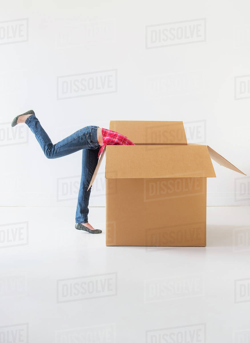 Studio shot of young woman looking into box - Royalty-free Stock Photo ...