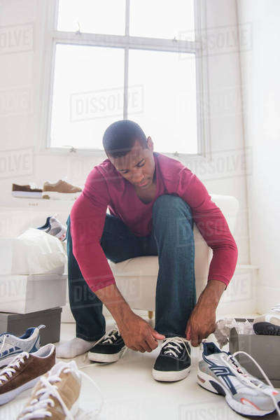 Young man in shoes store - Stock Photo - Dissolve