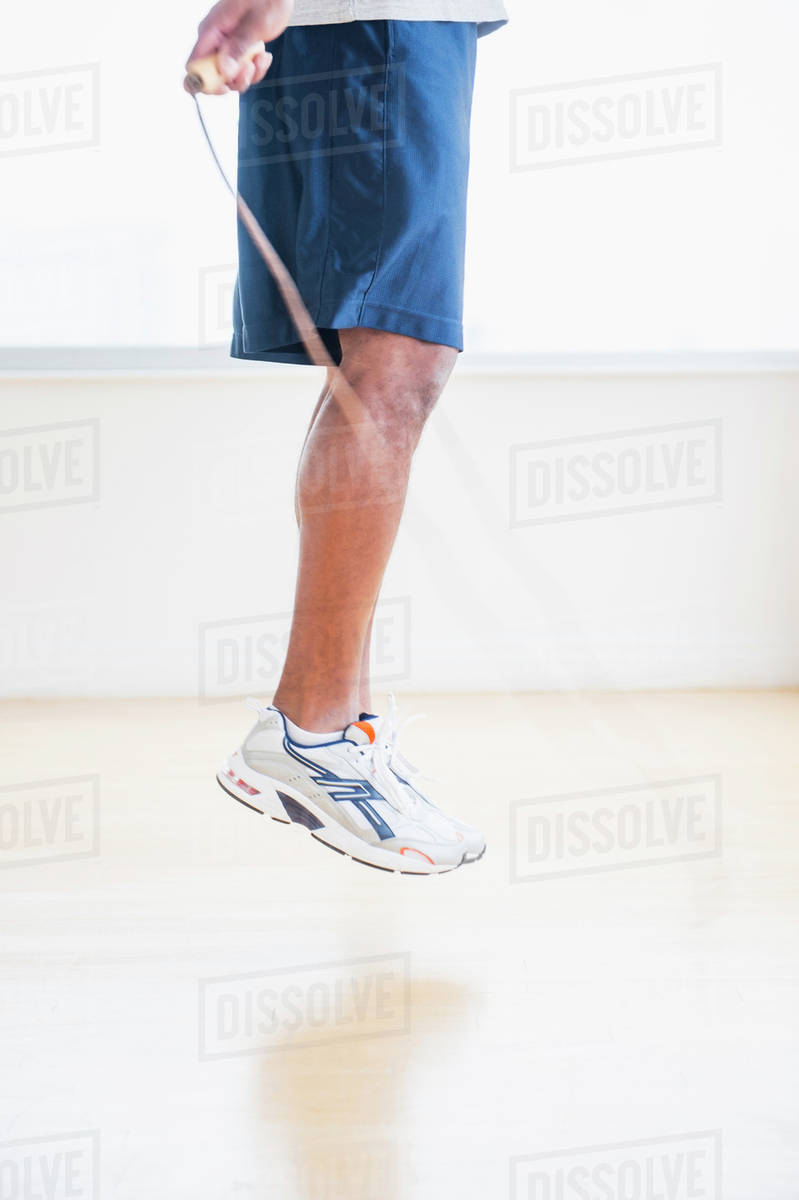 Young man skipping rope - Stock Photo - Dissolve