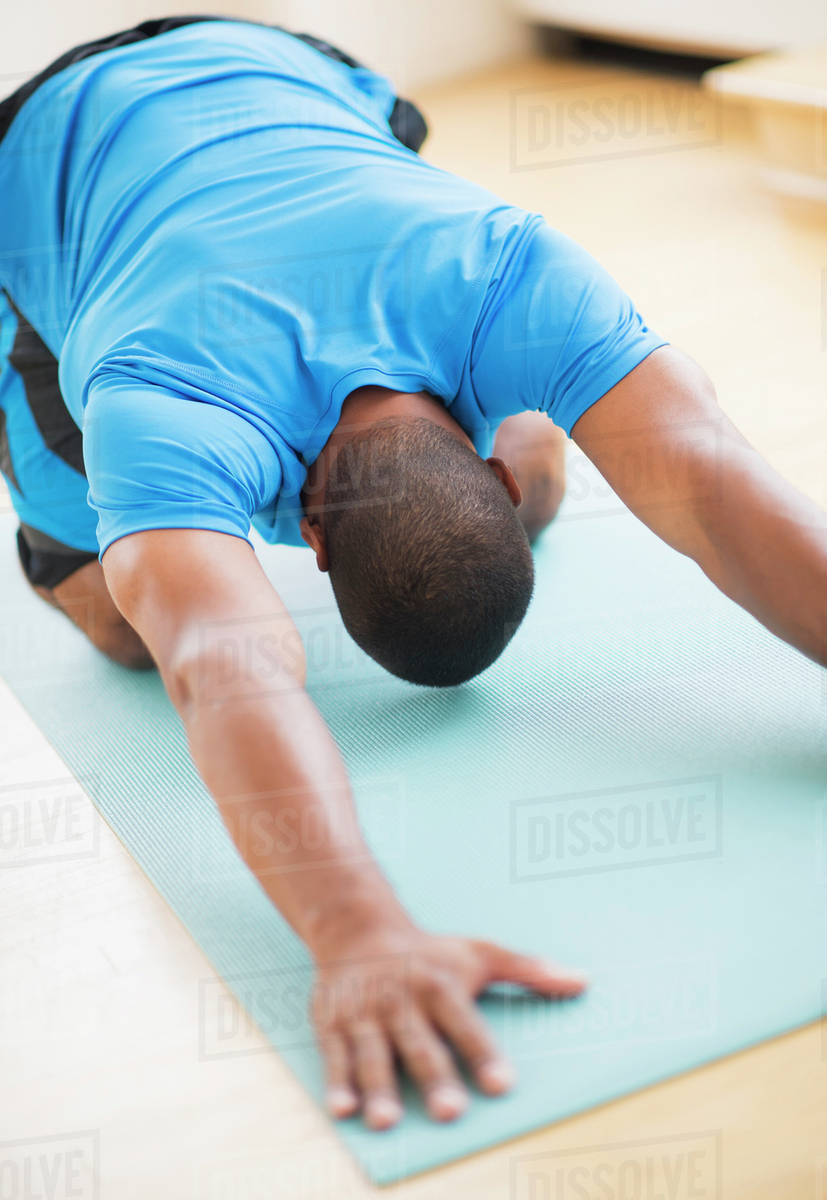 Young man practicing yoga - Royalty-free Stock Photo | Dissolve