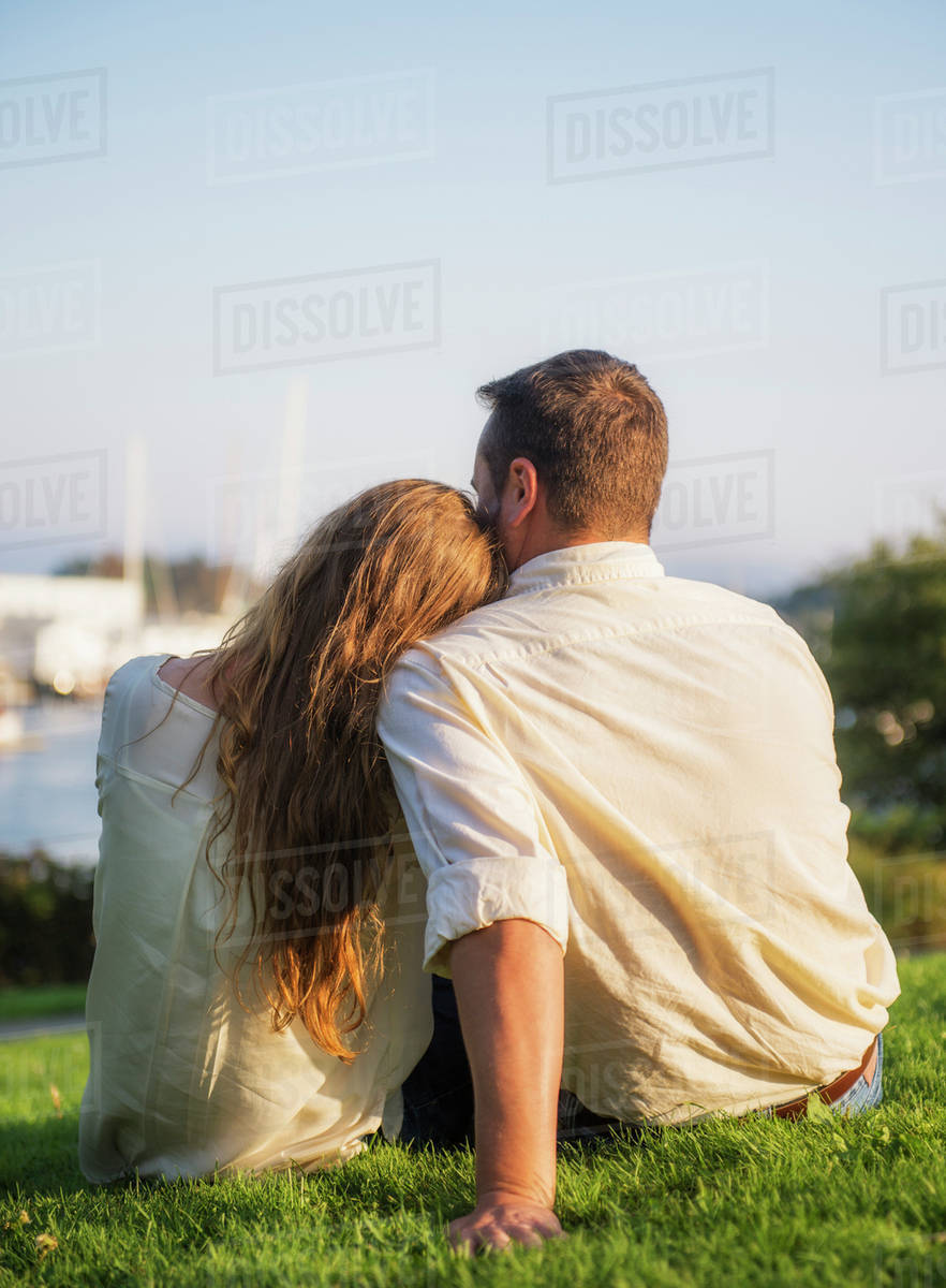 Back view of couple looking at harbor - Royalty-free Stock Photo | Dissolve