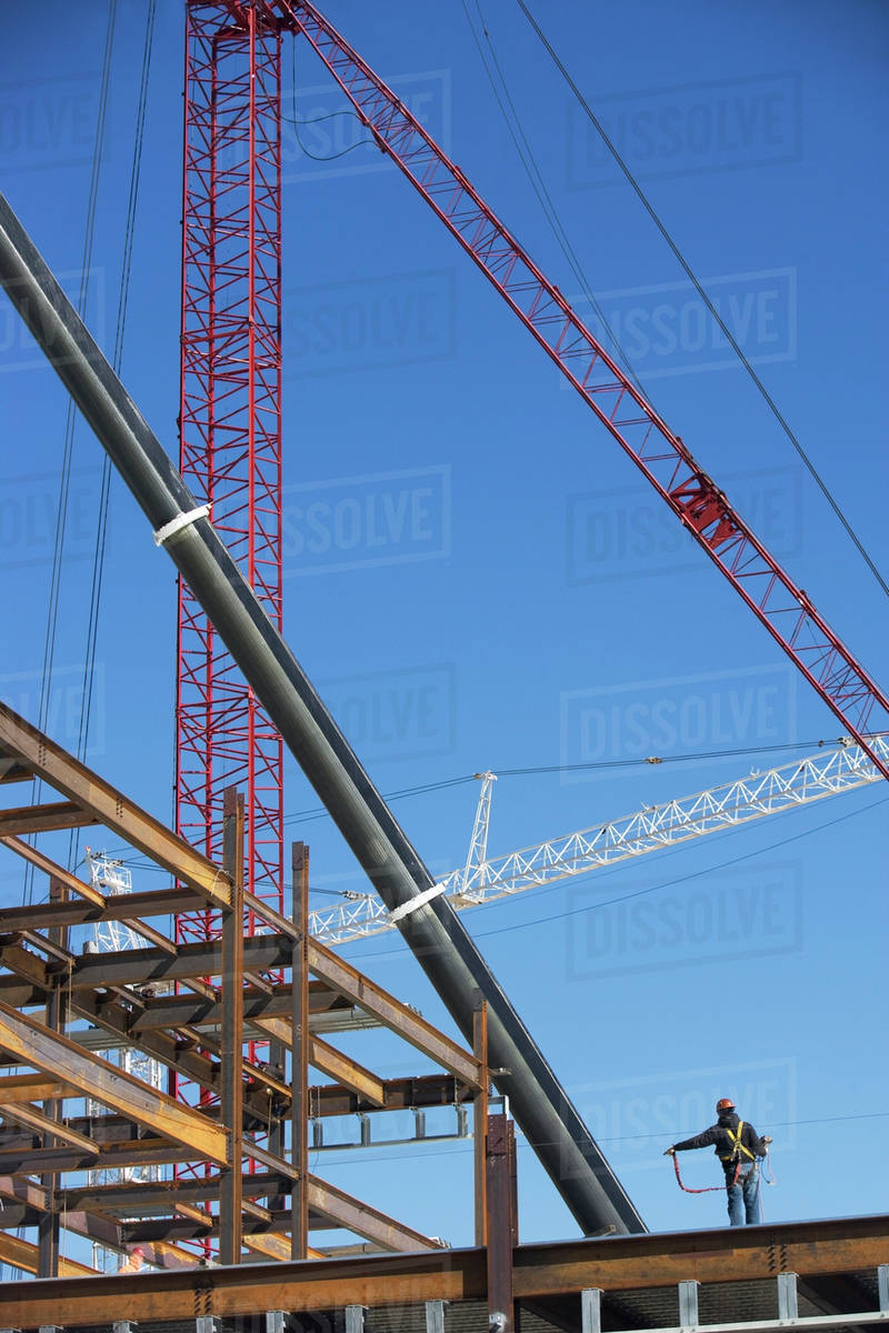 Construction worker on construction frame - Stock Photo - Dissolve