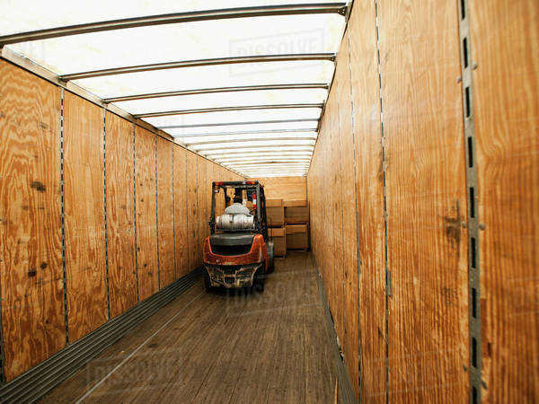 Forklift truck inside trailer - Stock Photo - Dissolve