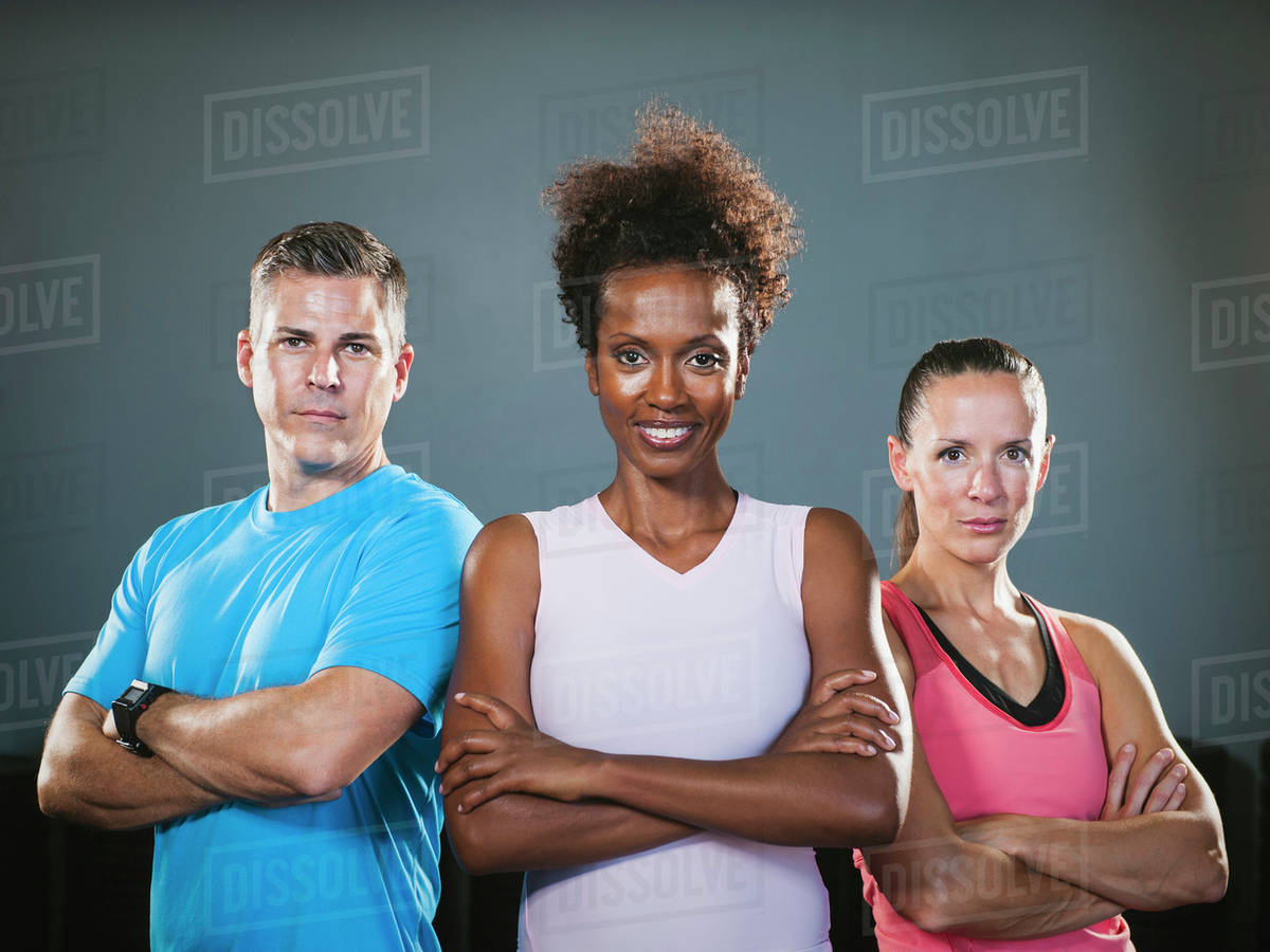 Portrait of three people with crossed arms - Stock Photo - Dissolve