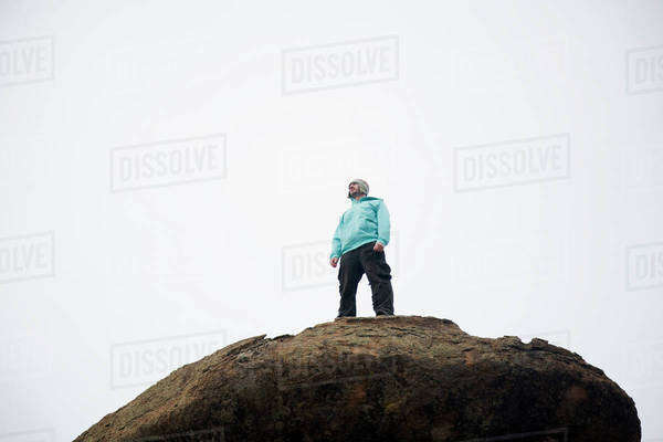 Man standing on rock - Royalty-free Stock Photo | Dissolve