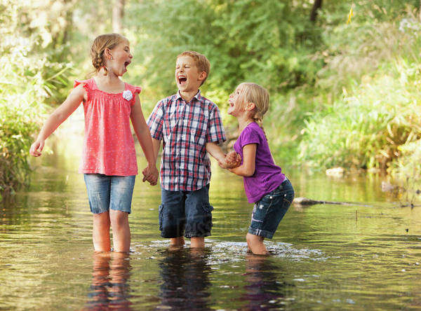 Three kids (4-5, 6-7) playing together in small stream - Royalty-free ...