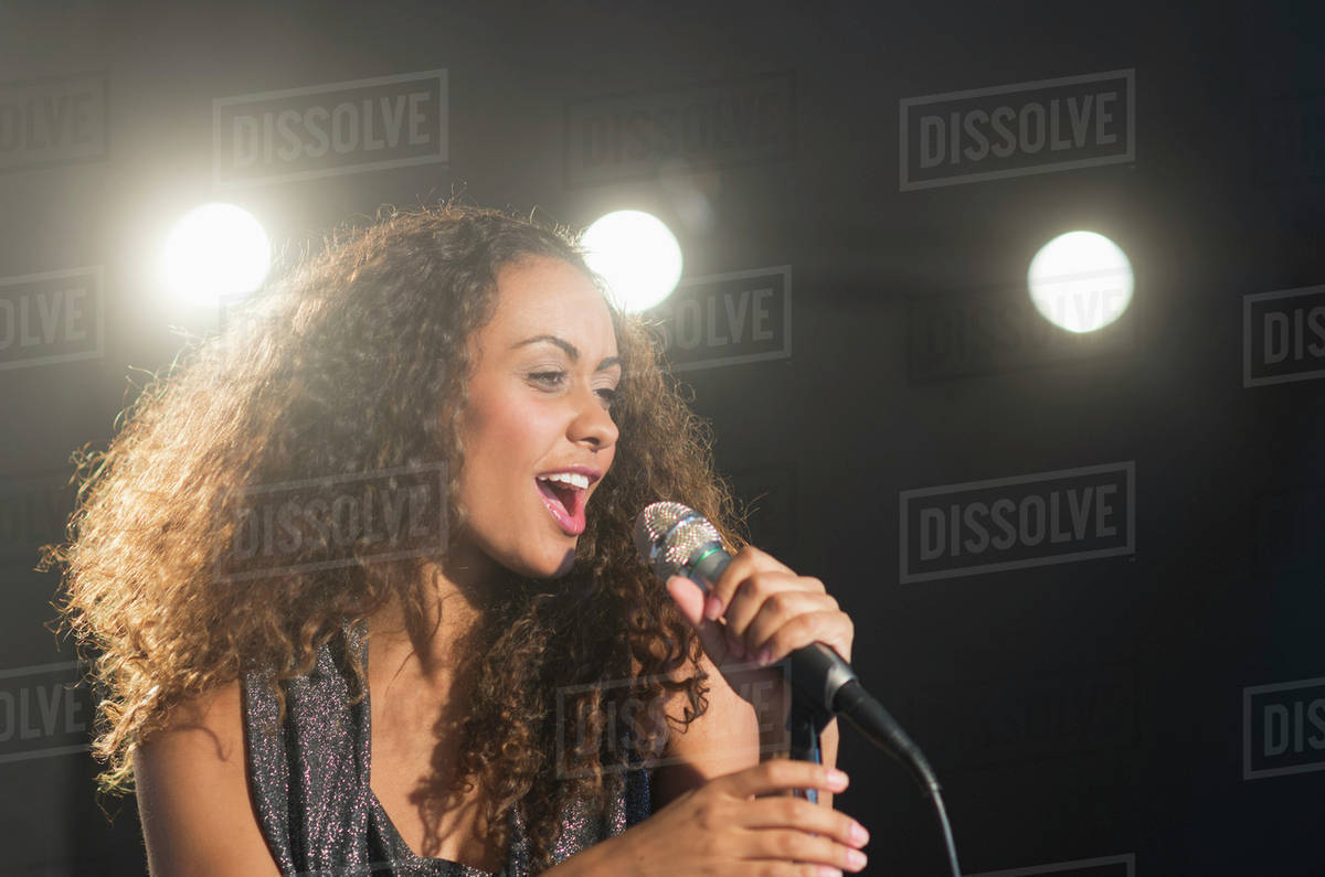 Stage performance of young singer - Royalty-free Stock Photo | Dissolve
