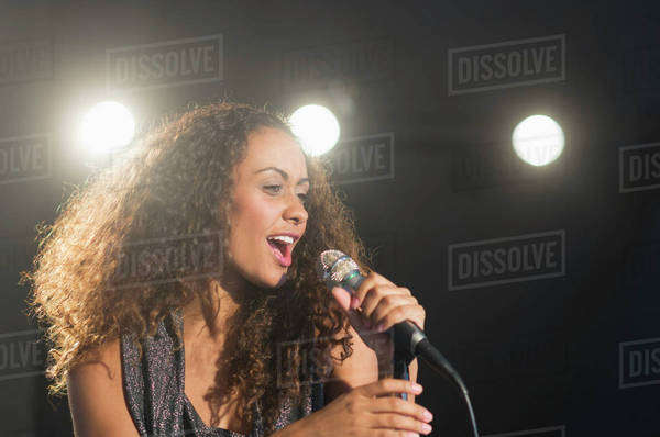 Stage performance of young singer - Royalty-free Stock Photo | Dissolve