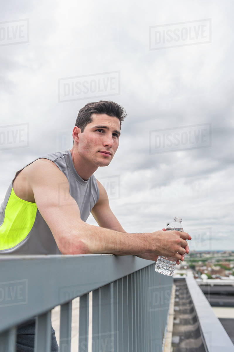 Athlete leaning against railing - Royalty-free Stock Photo | Dissolve
