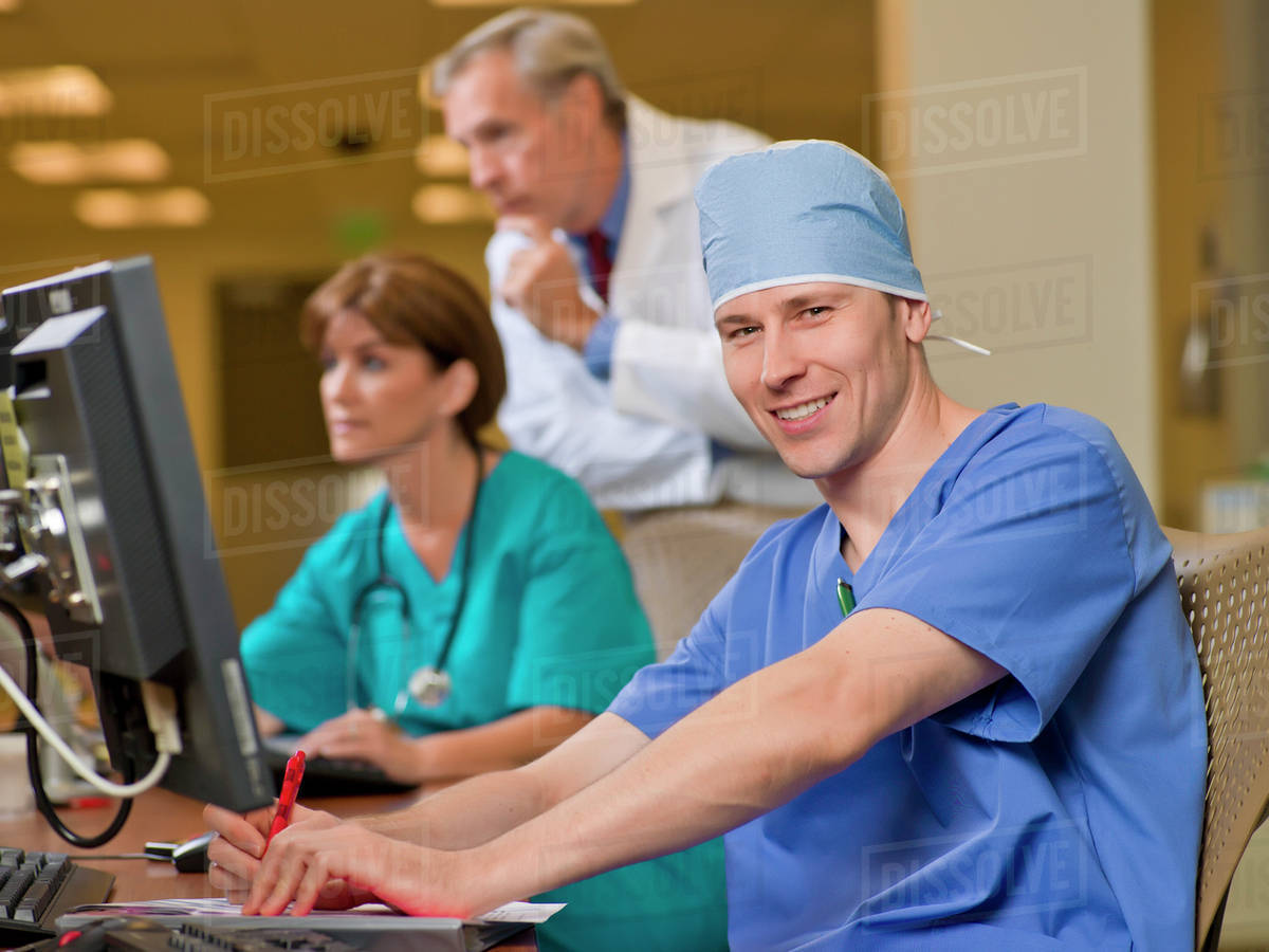 Doctor and surgeons working on computers in hospital - Royalty-free ...