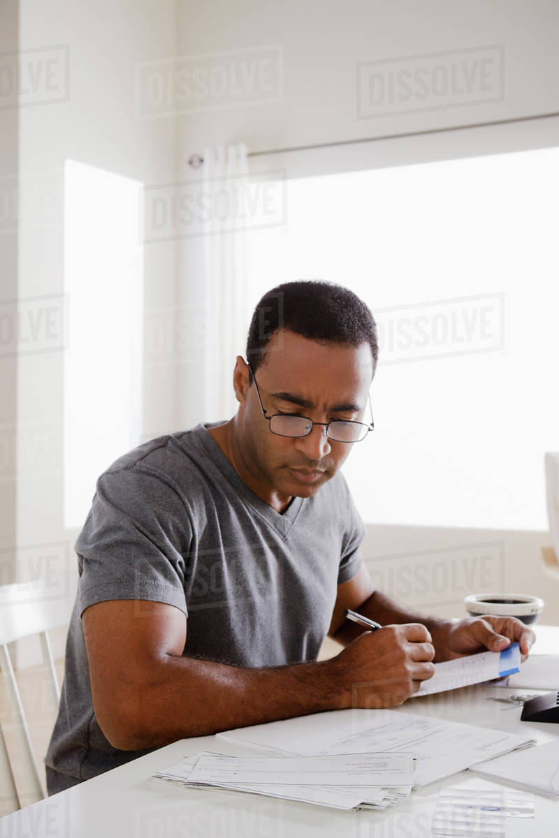 Mature man using calculator - Royalty-free Stock Photo | Dissolve