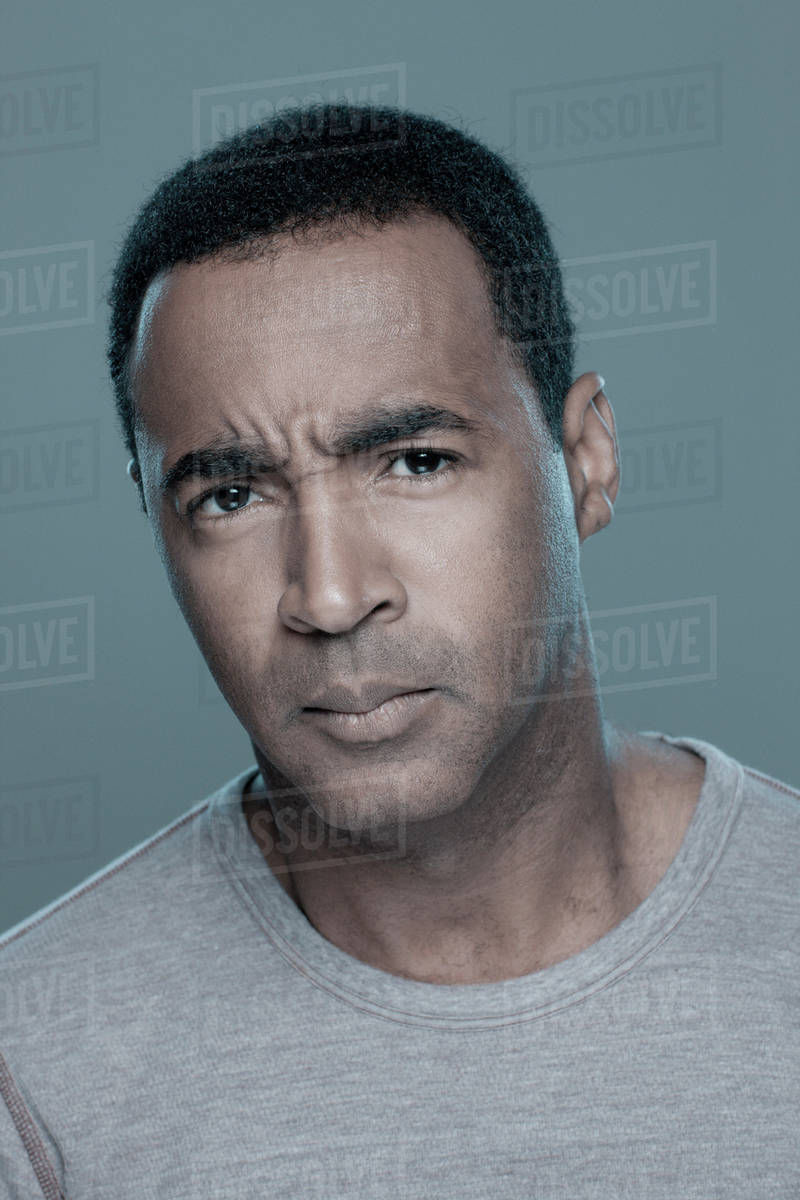 Studio shot of confused man - Royalty-free Stock Photo | Dissolve