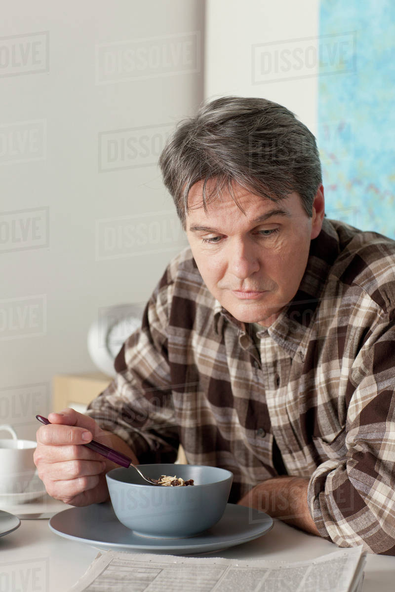 Man eating breakfast and reading newspaper - Royalty-free Stock Photo ...