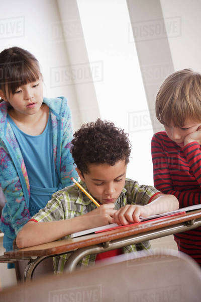 Three children (6-7, 8-9) at school - Royalty-free Stock Photo | Dissolve
