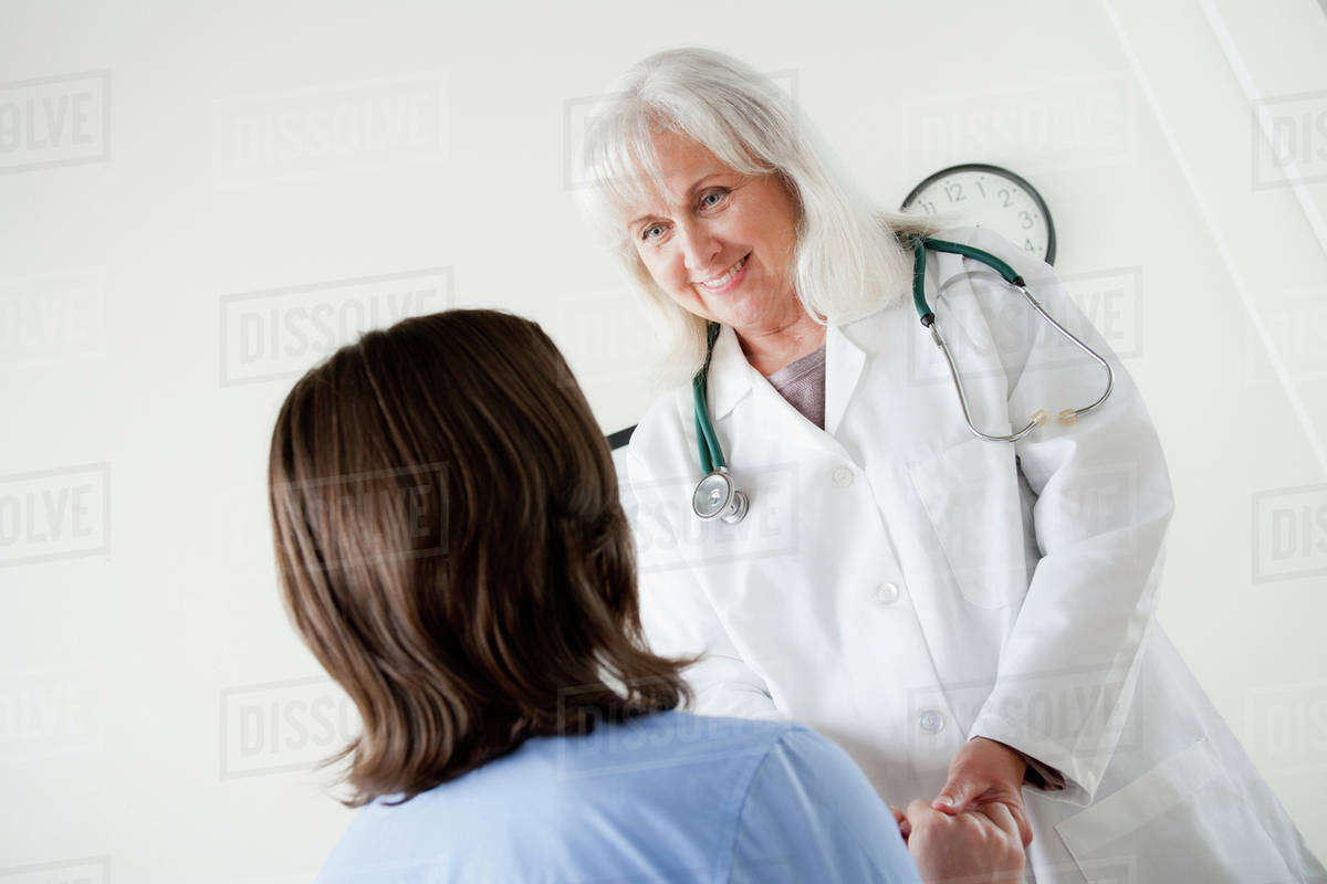 Senior doctor talking with patient - Royalty-free Stock Photo | Dissolve