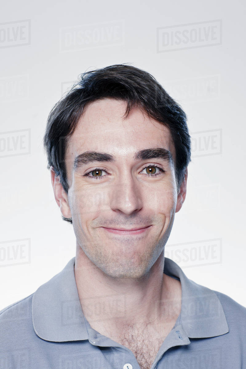 Portrait of smiling man, studio shot - Stock Photo - Dissolve