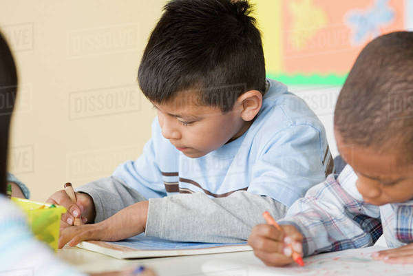 Children (6-7) drawing in classroom - Royalty-free Stock Photo | Dissolve