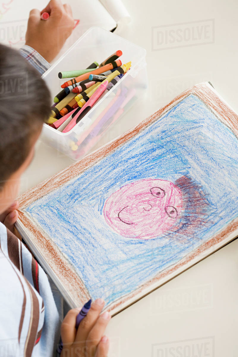 Boy (6-7) drawing in classroom - Royalty-free Stock Photo | Dissolve