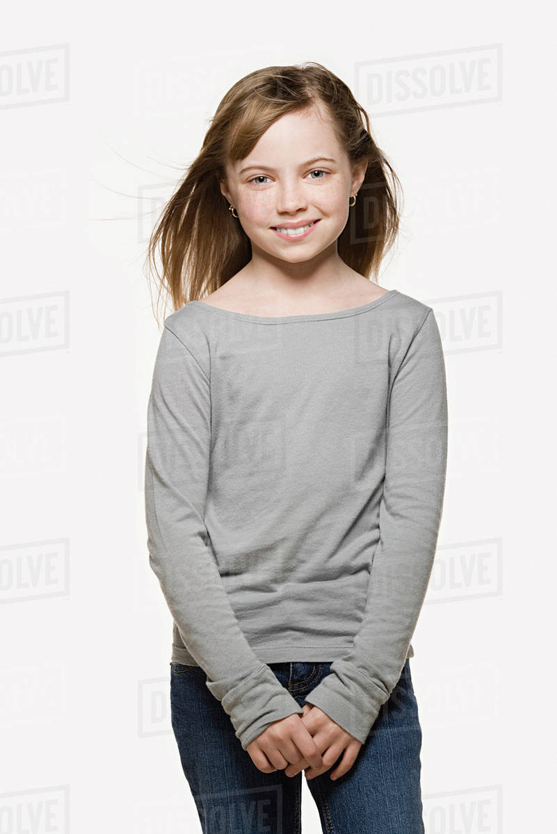 Studio portrait of smiling girl (8-9) - Royalty-free Stock Photo | Dissolve