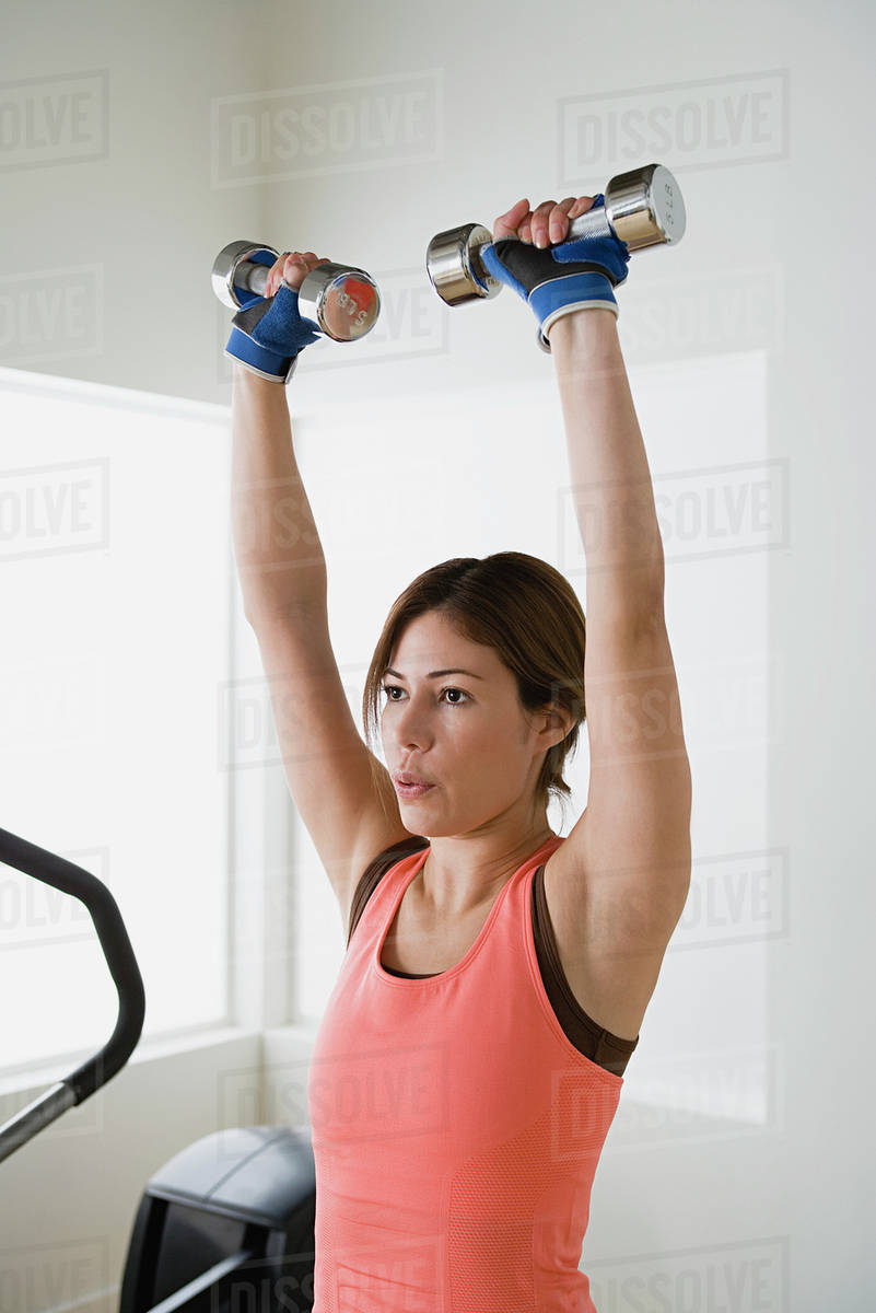 Woman lifting dumbbells - Royalty-free Stock Photo | Dissolve