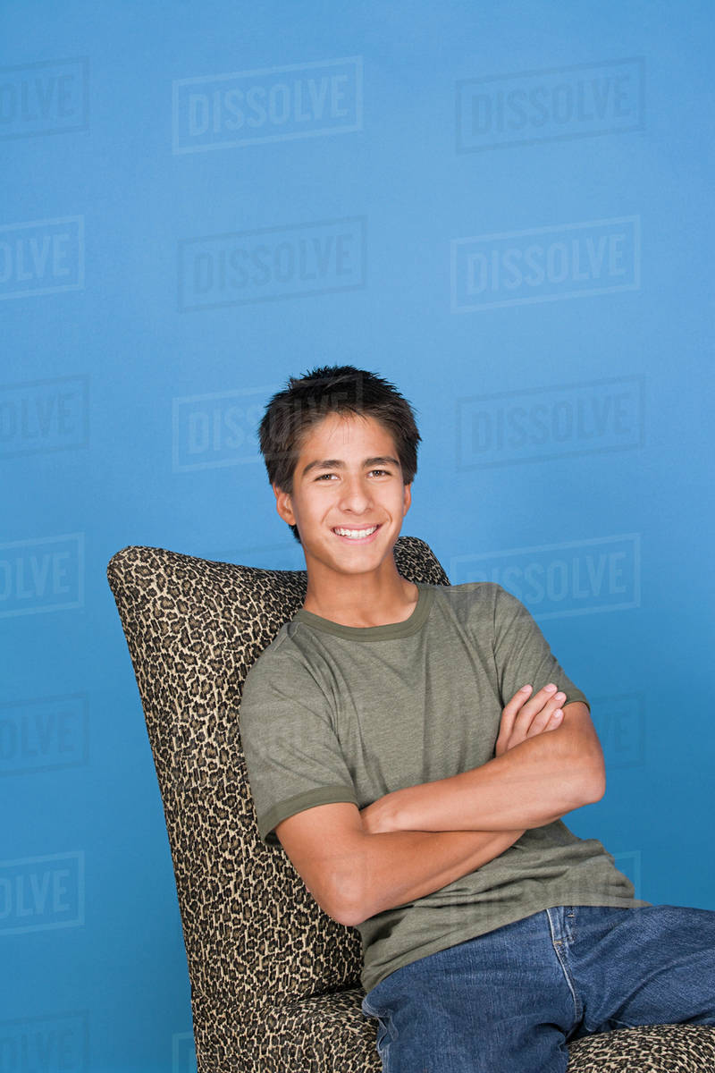 Portrait of teenage boy (16-17) sitting in chair - Royalty-free Stock ...