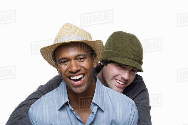 Studio portrait of two young men embracing - Royalty-free Stock Photo ...
