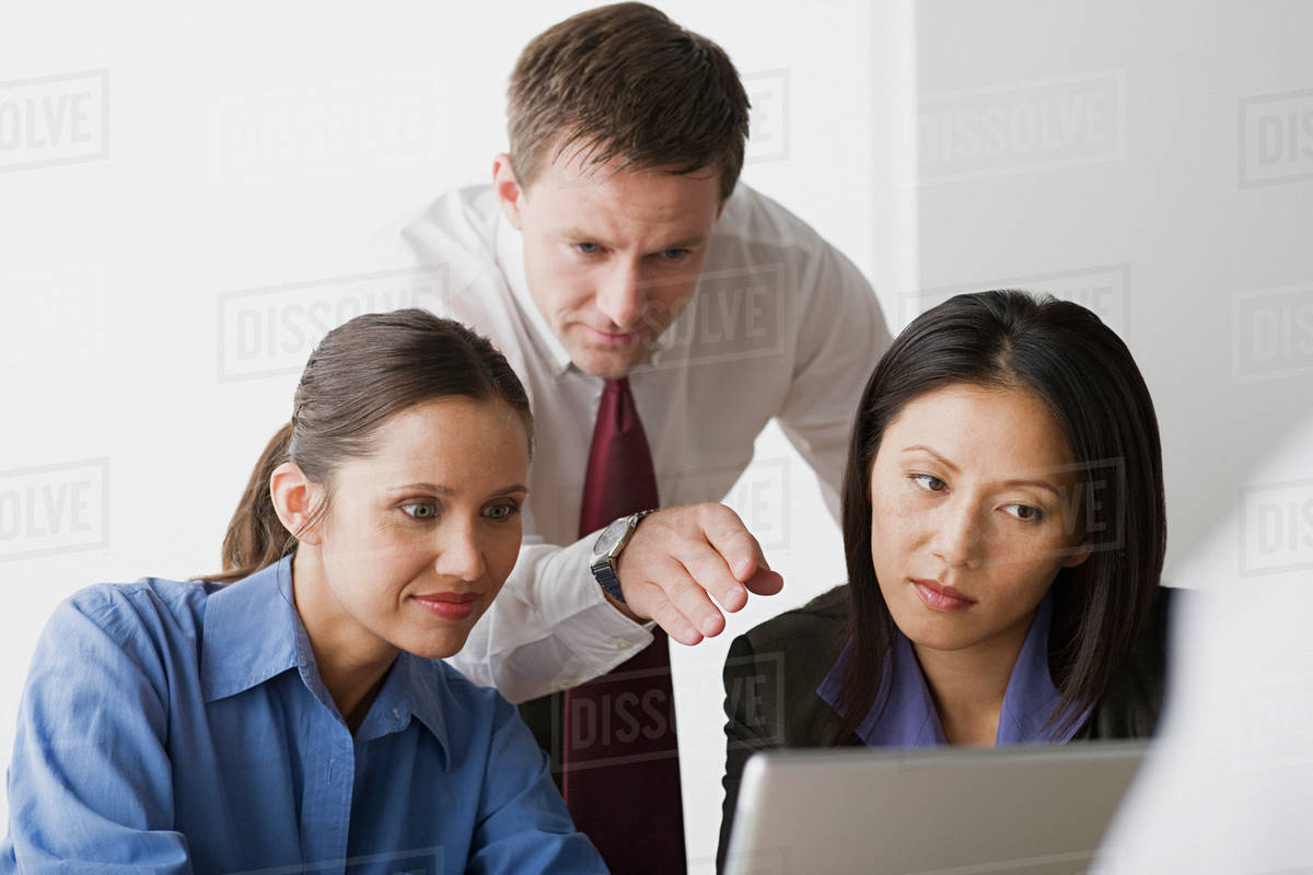 Three people working in office - Royalty-free Stock Photo | Dissolve