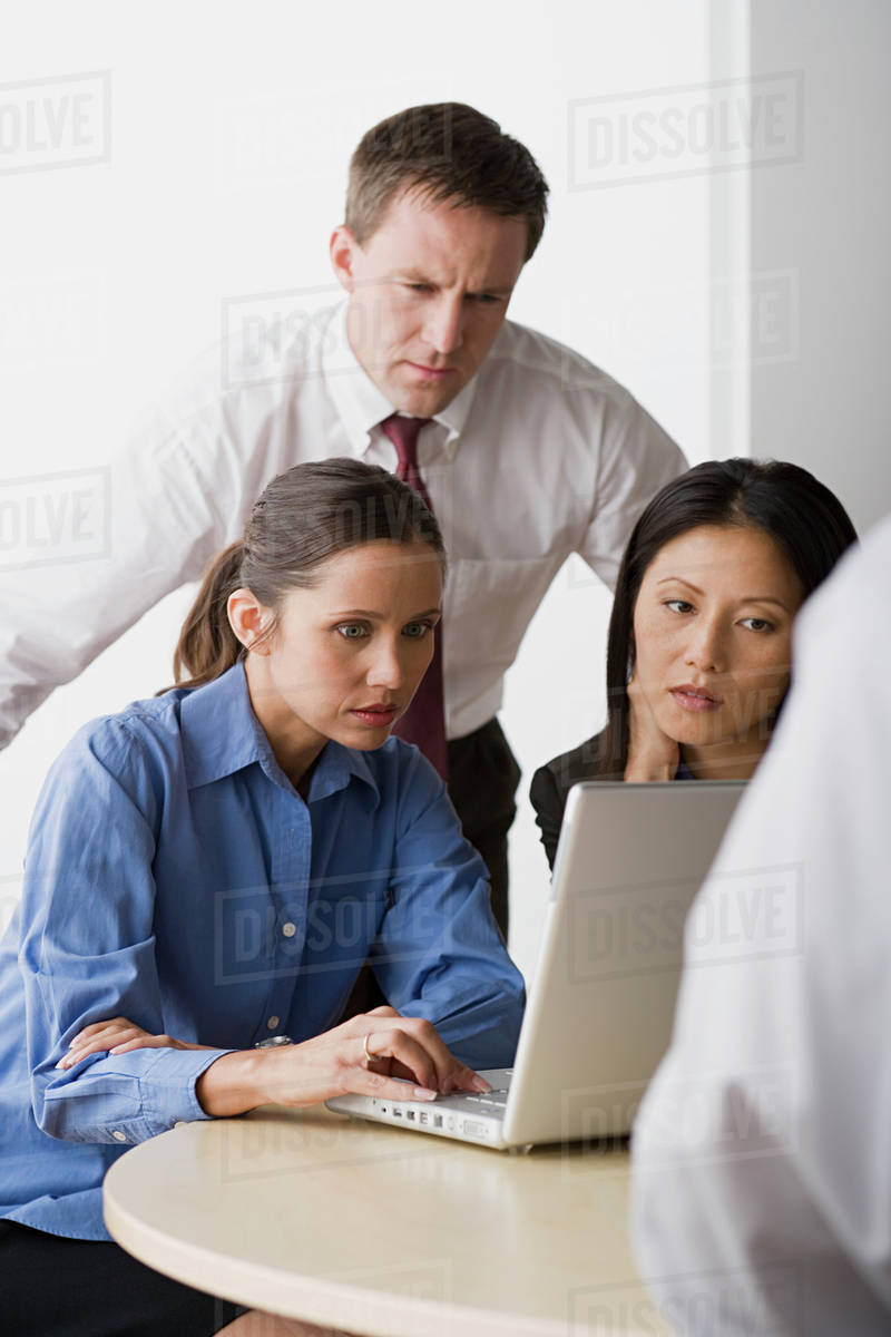 Three people working in office - Royalty-free Stock Photo | Dissolve