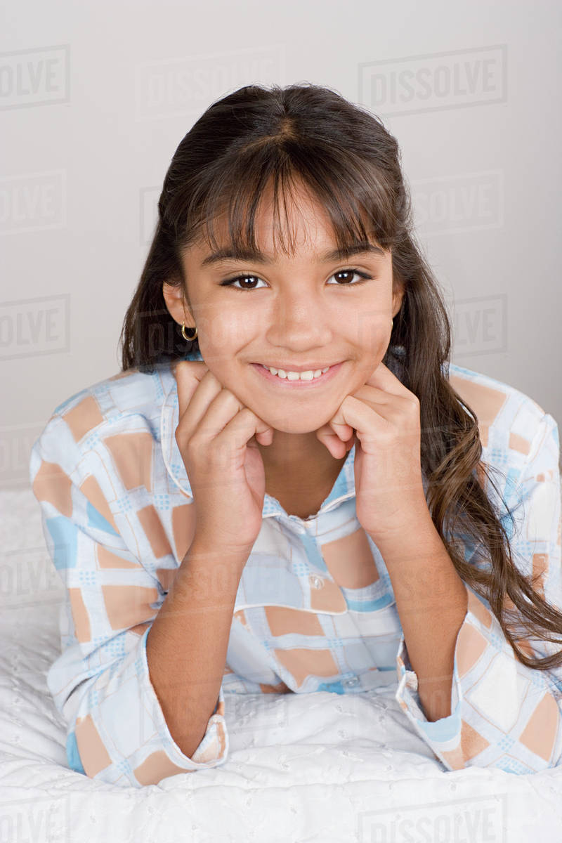 Portrait of smiling girl (10-11) in pajamas - Royalty-free Stock Photo ...