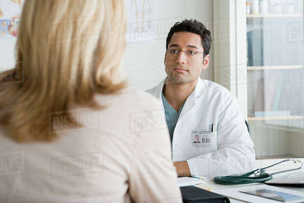 Doctor listening to patient - Royalty-free Stock Photo | Dissolve
