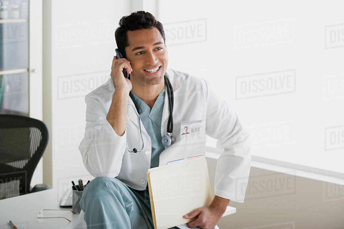 Doctor talking on mobile phone - Stock Photo - Dissolve