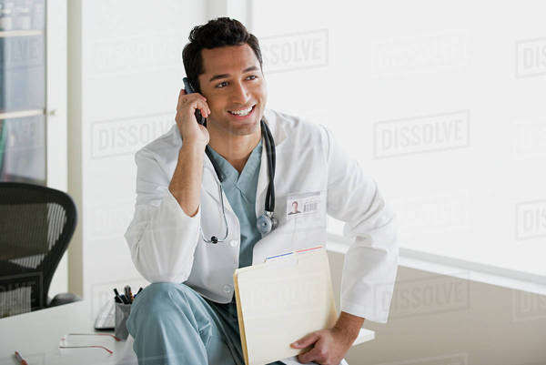 Doctor talking on mobile phone - Stock Photo - Dissolve