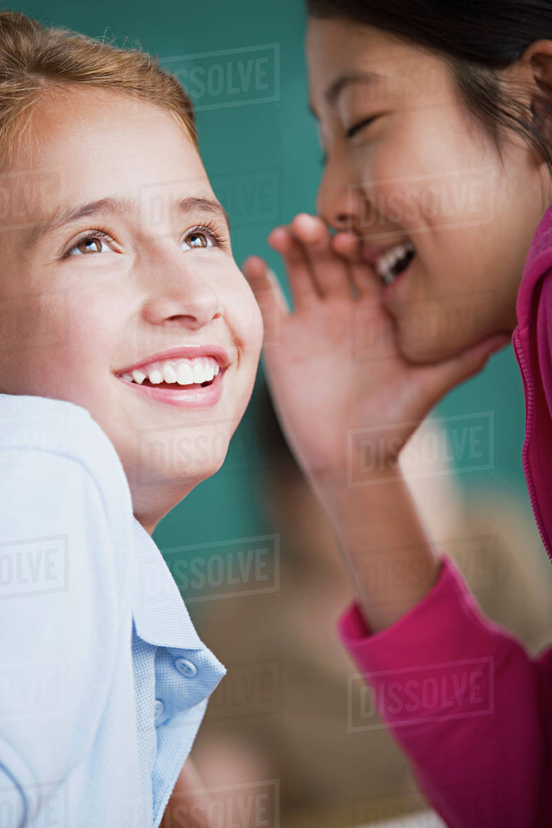 Two girls gossiping - Stock Photo - Dissolve