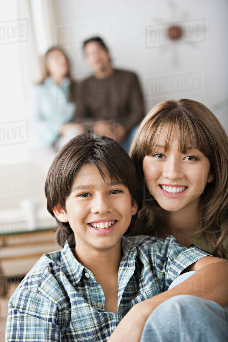 Portrait of brother and sister, parents in background - Stock Photo ...