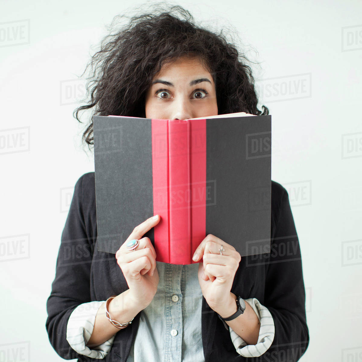 Happy young woman posing with book - Royalty-free Stock Photo | Dissolve