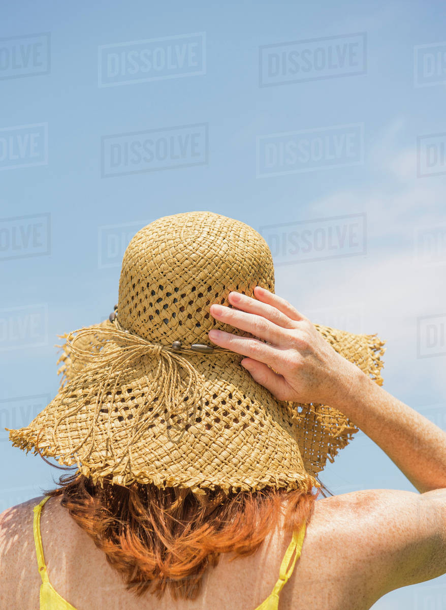 Woman wearing straw hat - Royalty-free Stock Photo | Dissolve