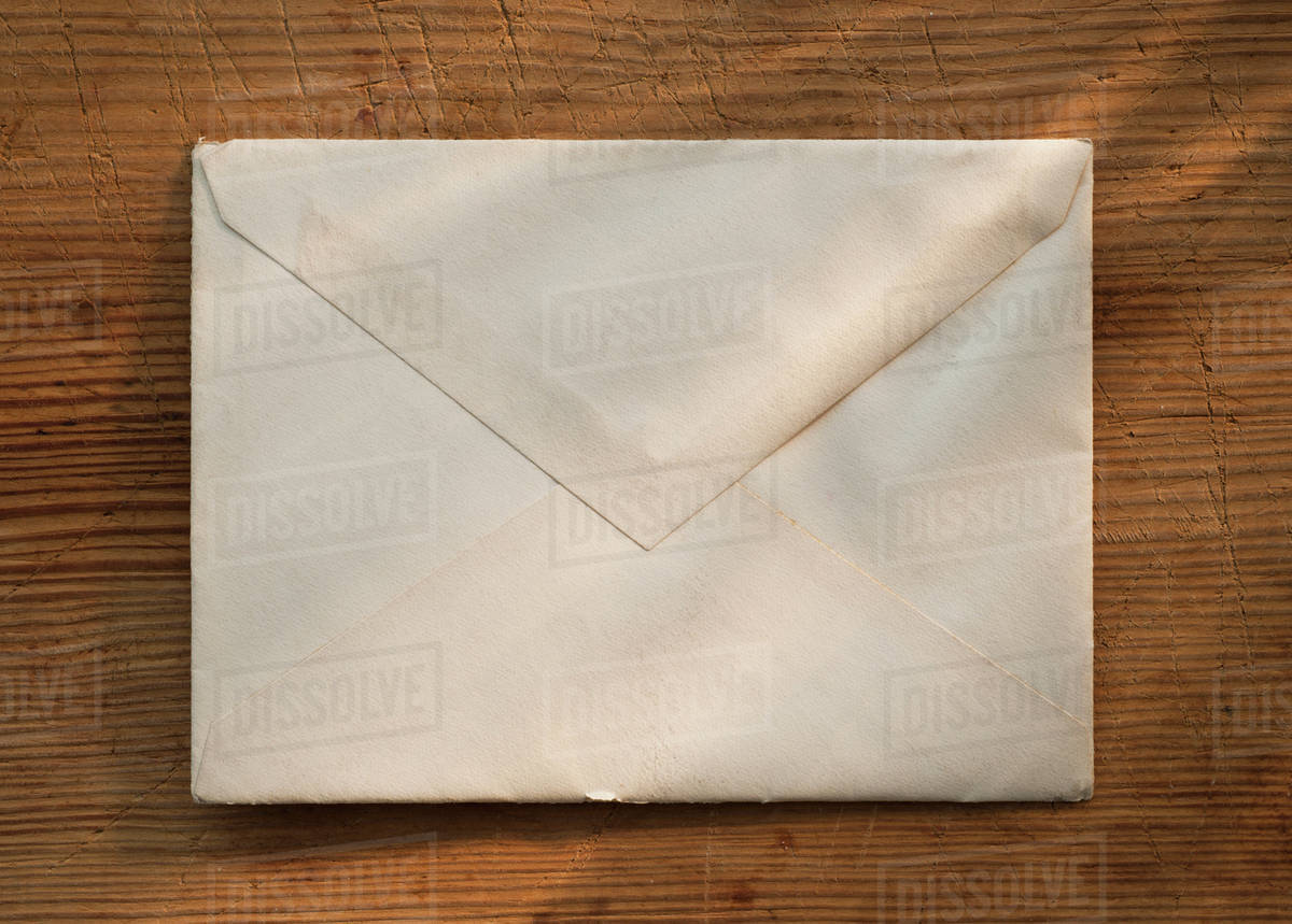 Blank envelope on wooden table - Royalty-free Stock Photo | Dissolve