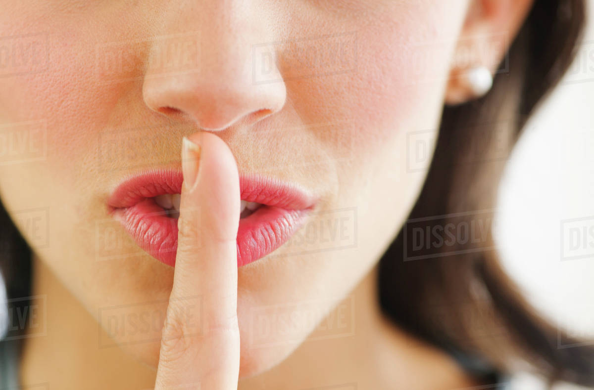 Young woman with finger on lips, close-up - Royalty-free Stock Photo ...