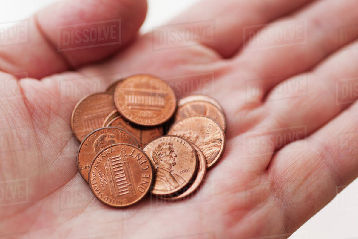 Male hand holding coins - Royalty-free Stock Photo | Dissolve