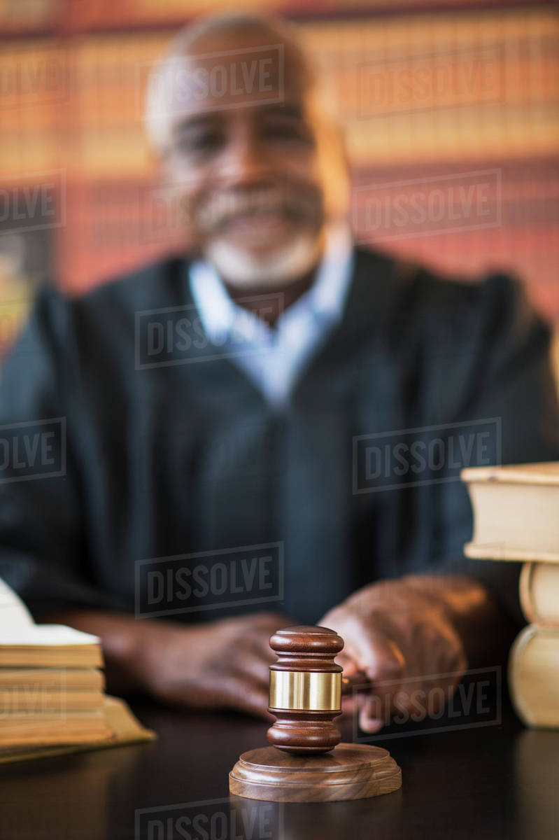 Judge holding gavel in courtroom - Royalty-free Stock Photo | Dissolve