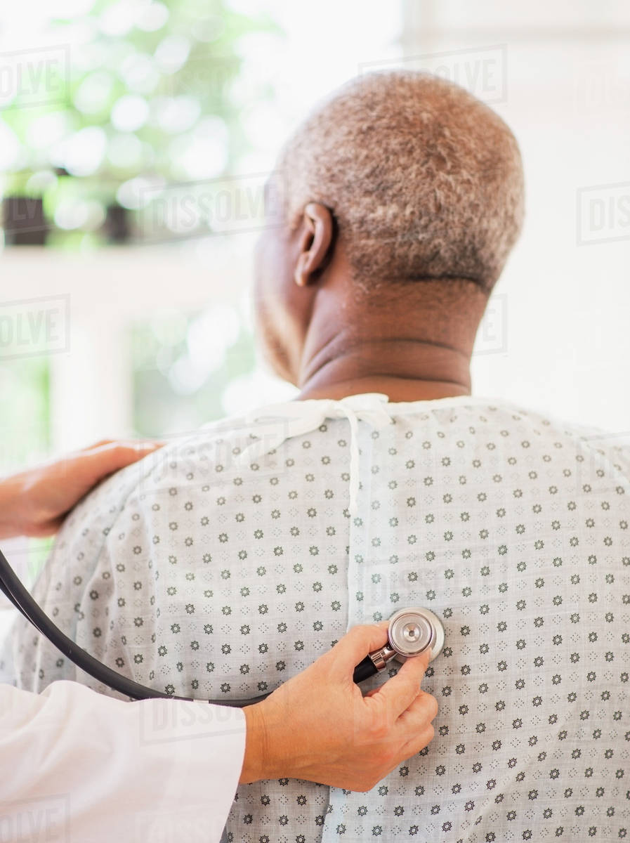 Doctor using stethoscope on patient - Royalty-free Stock Photo | Dissolve