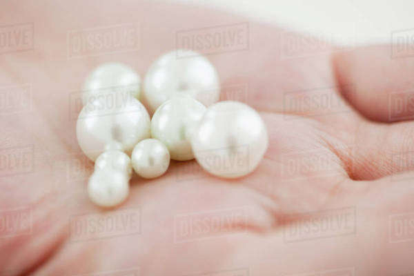 Woman holding pearl - Royalty-free Stock Photo | Dissolve