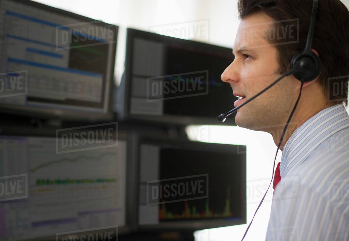 Financial worker analyzing data displayed on computer screen - Stock ...