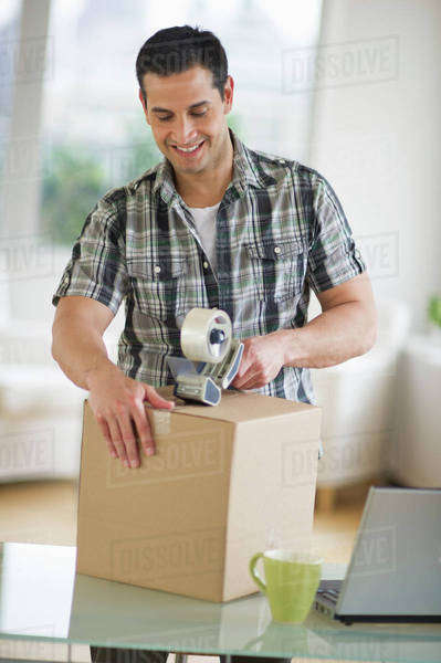 Man packing box - Stock Photo - Dissolve