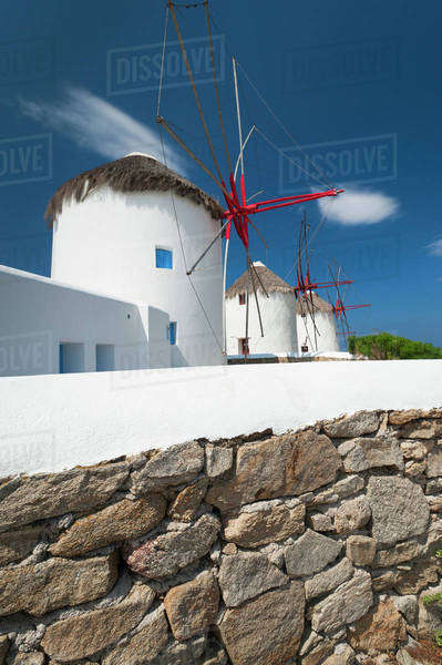 Greece, Cyclades Islands, Mykonos, Stone wall near old windmills ...
